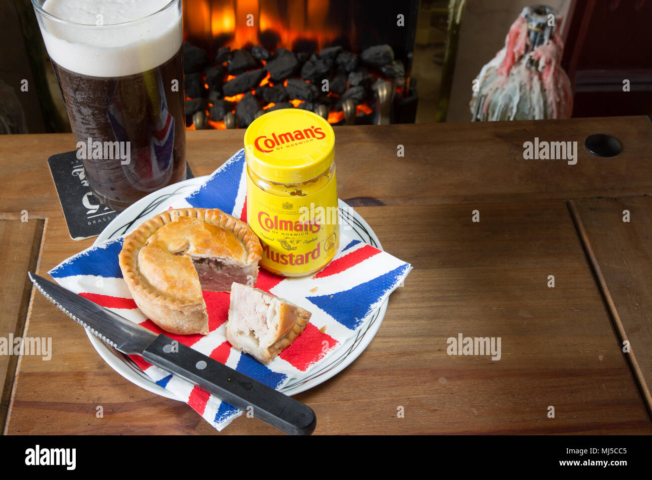 An English pub classic snack of Pork pie with Coleman's English mustard ...
