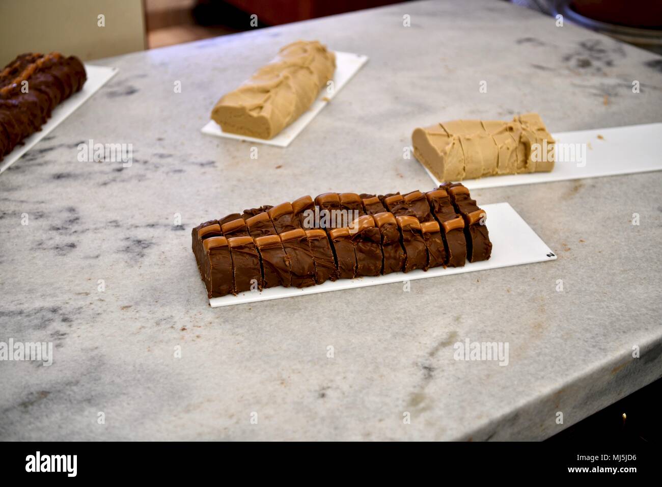 Freshly made fudge sliced and ready to order Stock Photo - Alamy