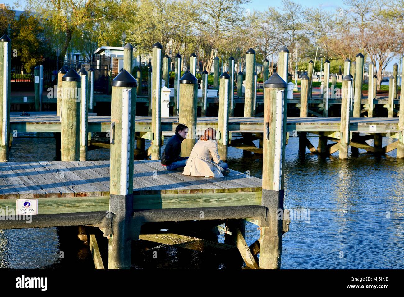 Man sitting on dock hi-res stock photography and images - Alamy