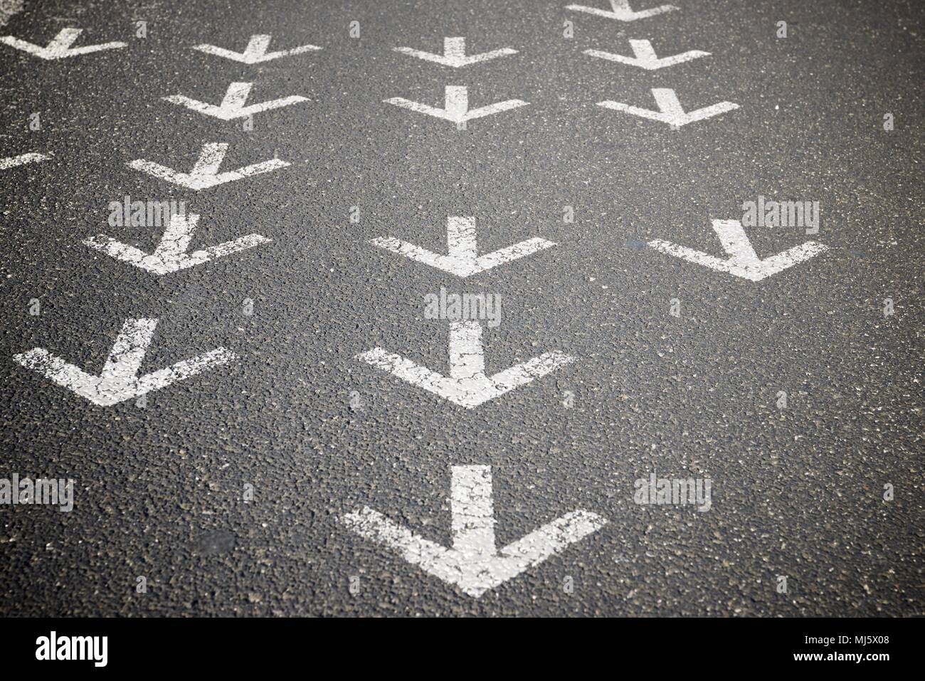 Directional arrows painted on a cement floor Stock Photo - Alamy