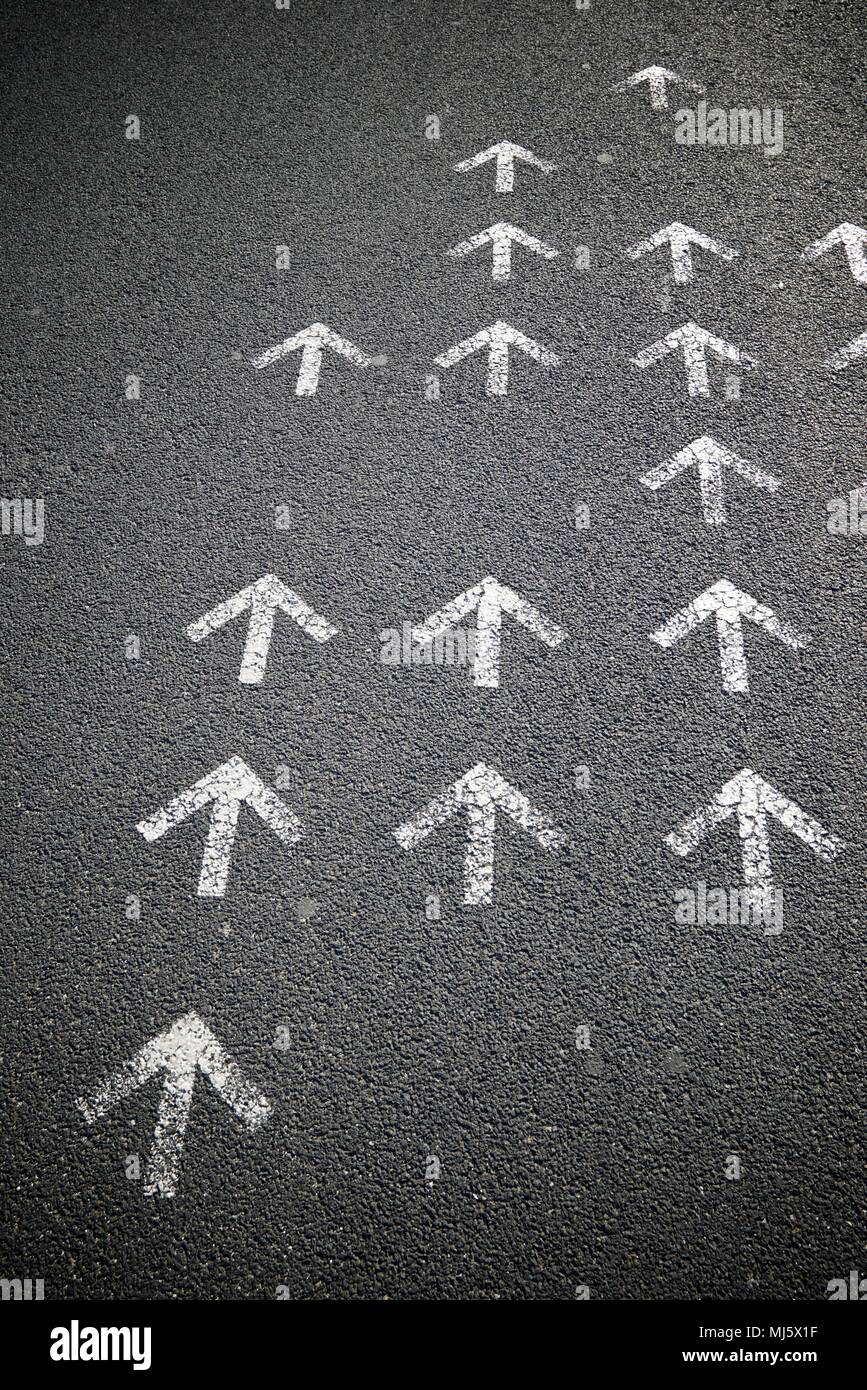 Directional arrows painted on a cement floor Stock Photo - Alamy