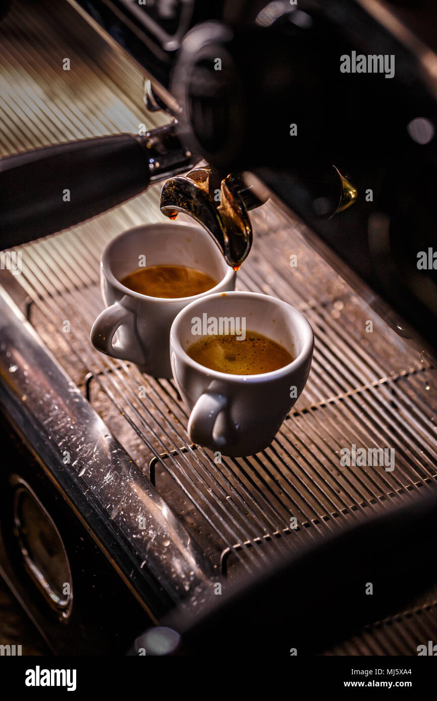 Coffee flowing from the nozzle automatic coffee maker Stock Photo - Alamy