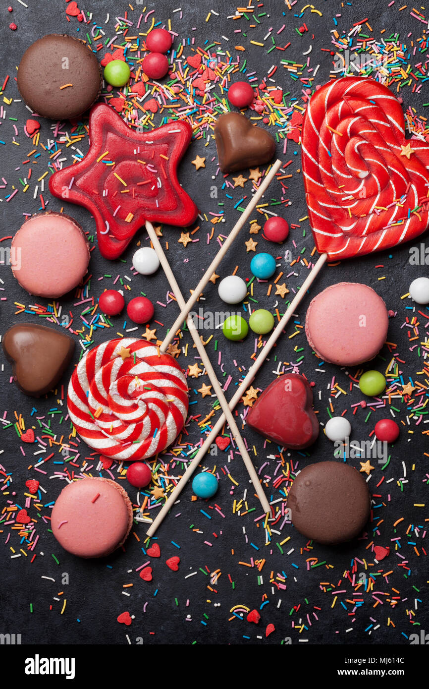 Colorful sweets. Lollipops, macaroons, candies. Top view Stock Photo ...