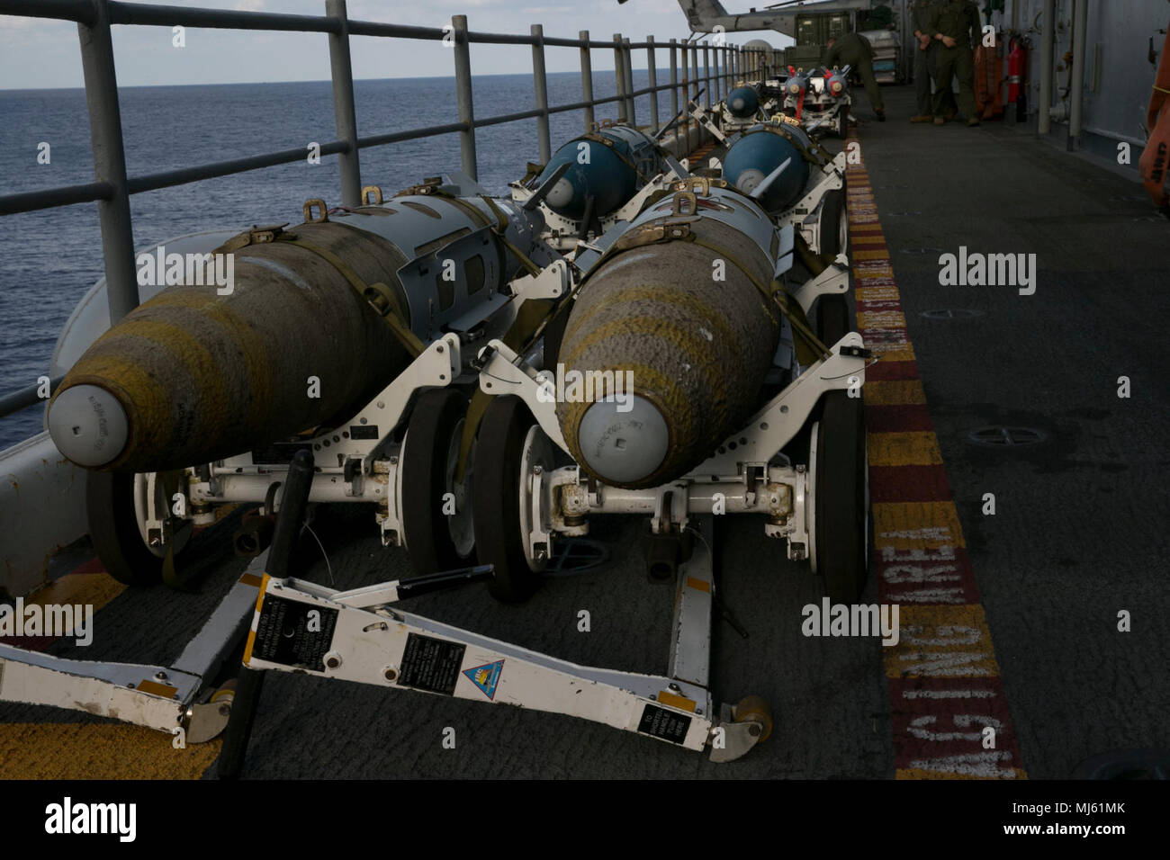 One thousand pound Guided Bomb Units sit staged on the flight deck of ...