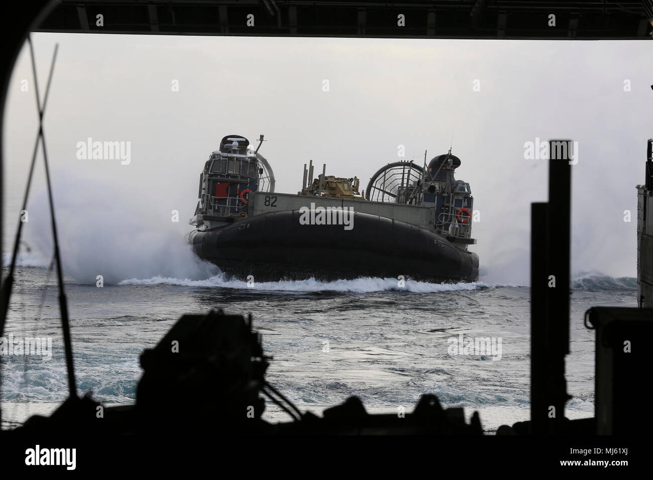 U.S. Navy sailors with Assault Craft Unit 5 pilot their Landing Craft ...