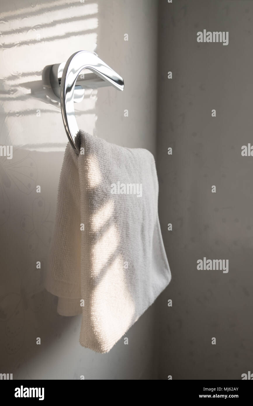 White clean towel on the steel shelf in bathroom Stock Photo - Alamy