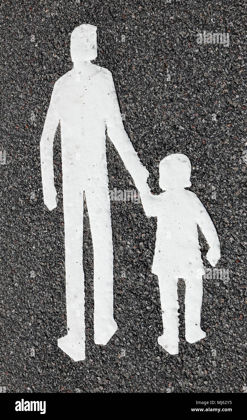 Road sign symbol painted on road surface showing a man holding young ...