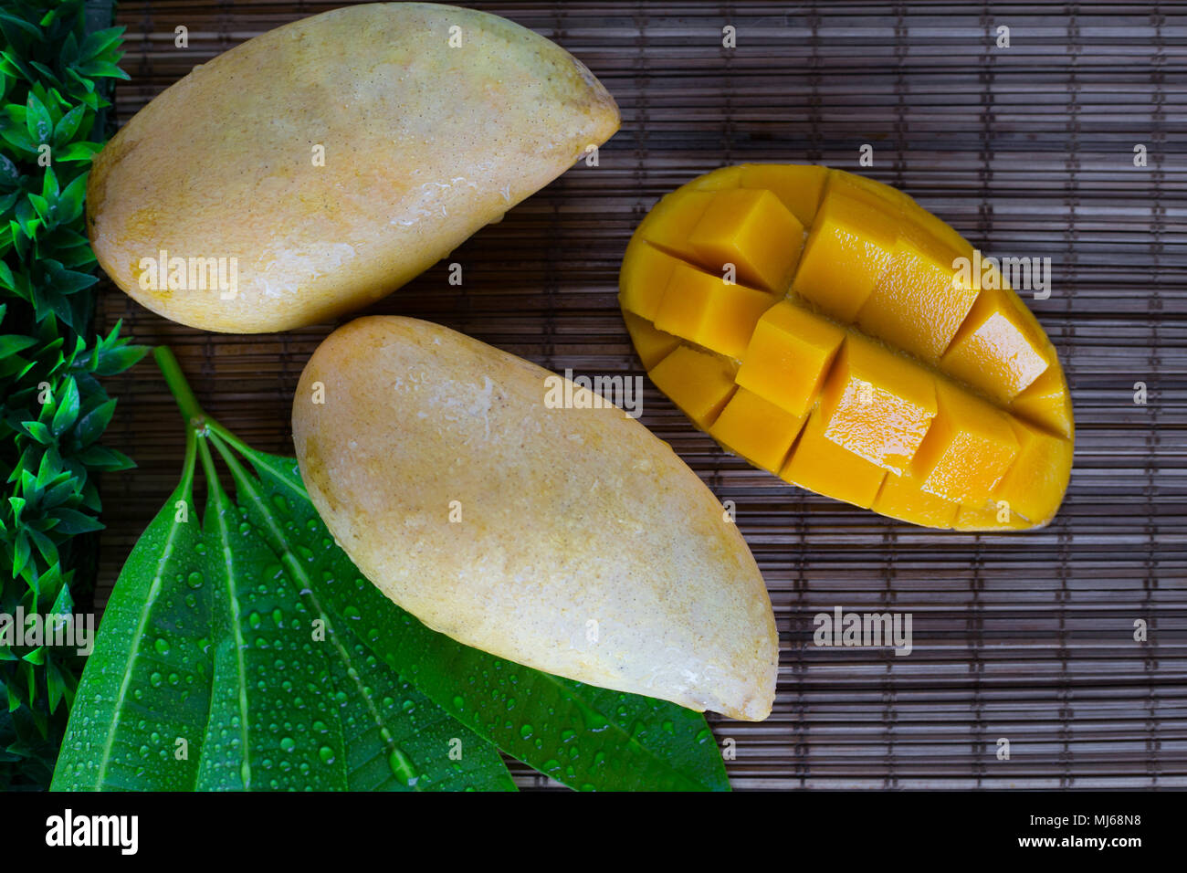Mango. Tropical Fruits. On a bamboo stick plate . flat lay Stock Photo ...