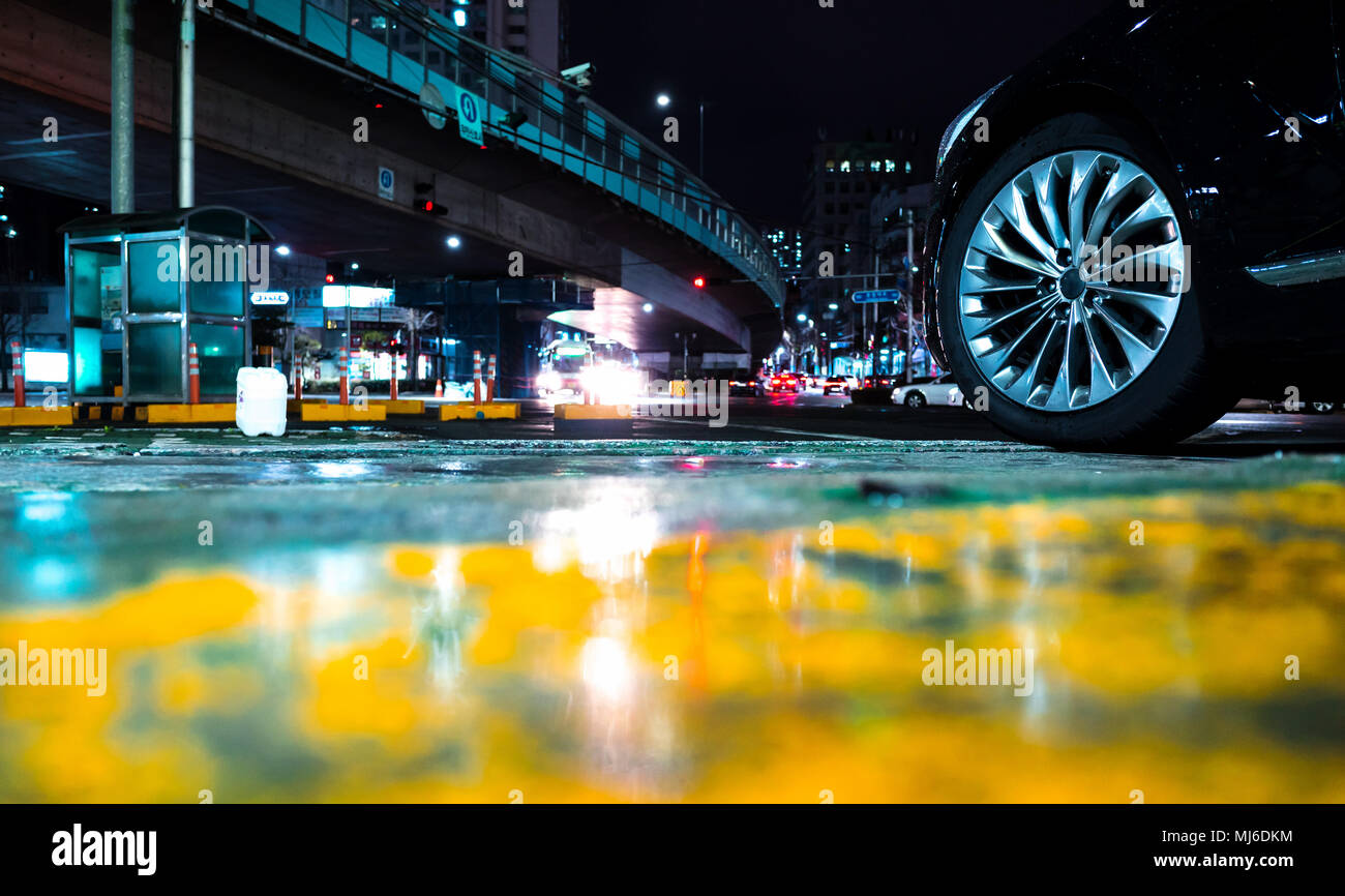 Abstract night street race background with car wheel on wet urban ...