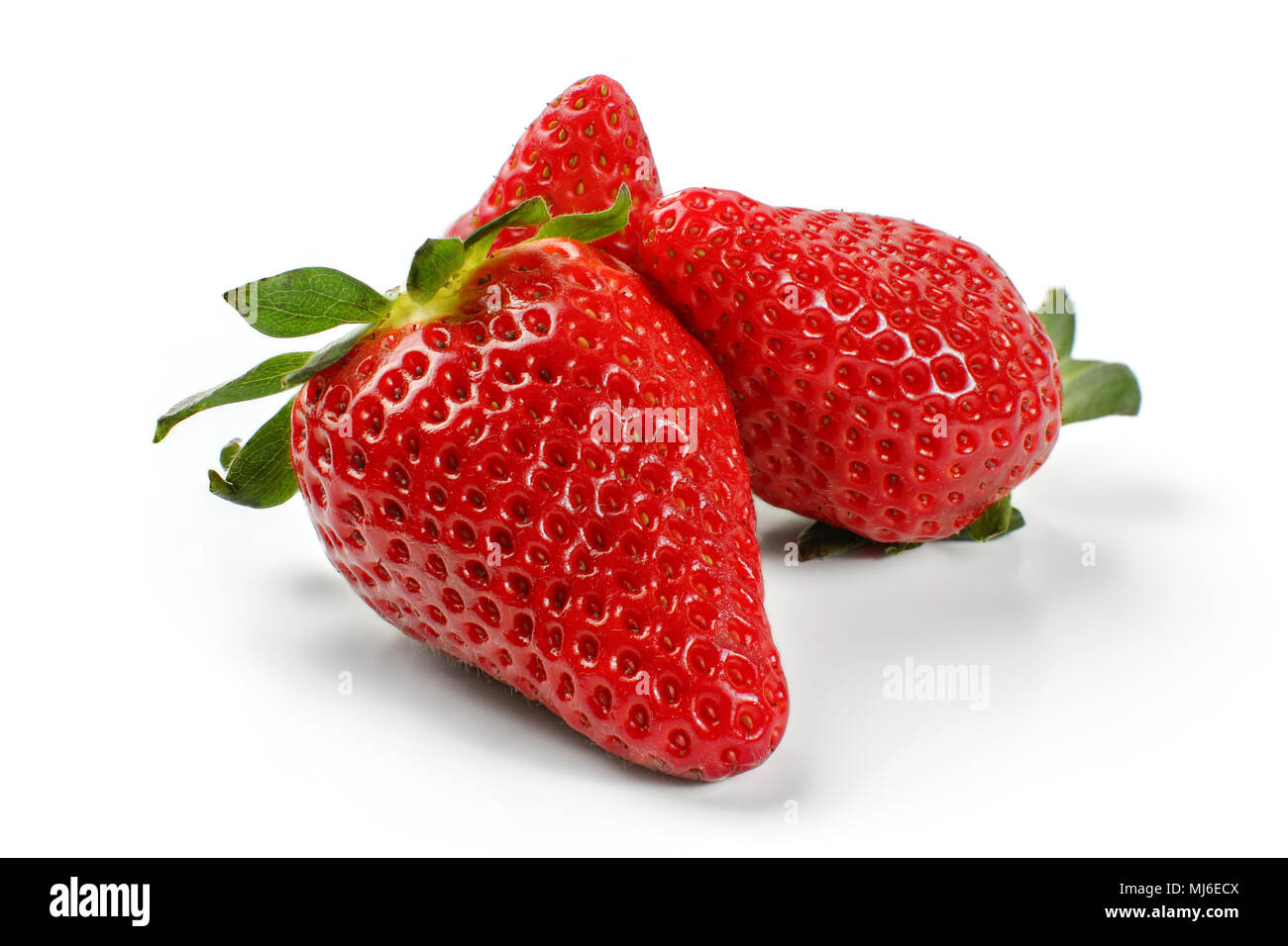 Three strawberries isolated on white background Stock Photo - Alamy