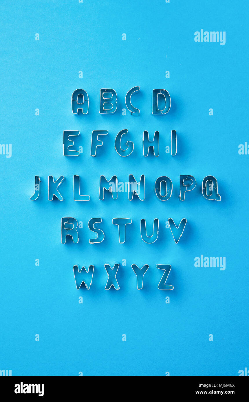 Alphabet letters organized over blue background, top view Stock Photo ...