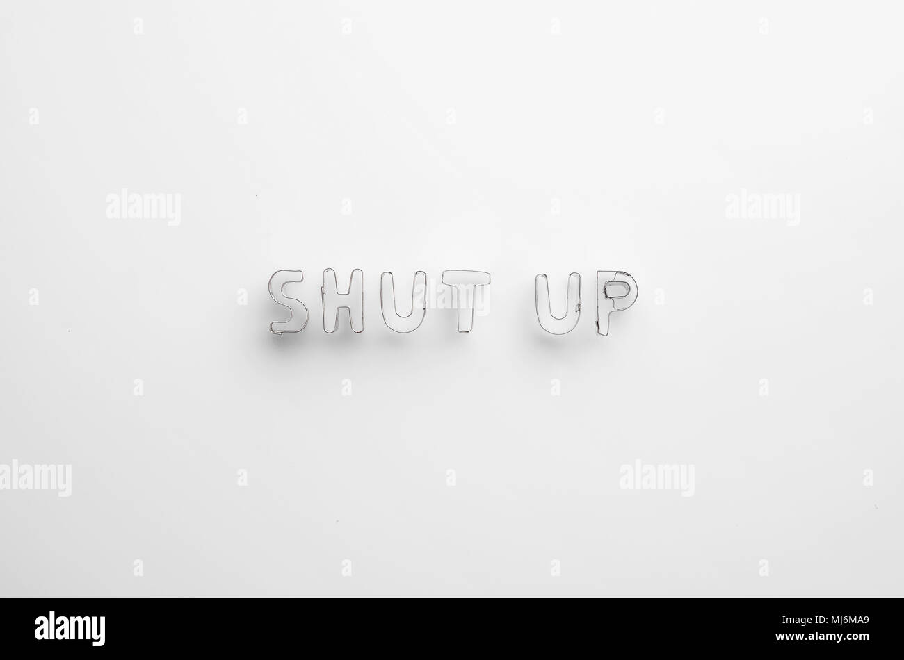 Shut up word over white background, top view Stock Photo - Alamy