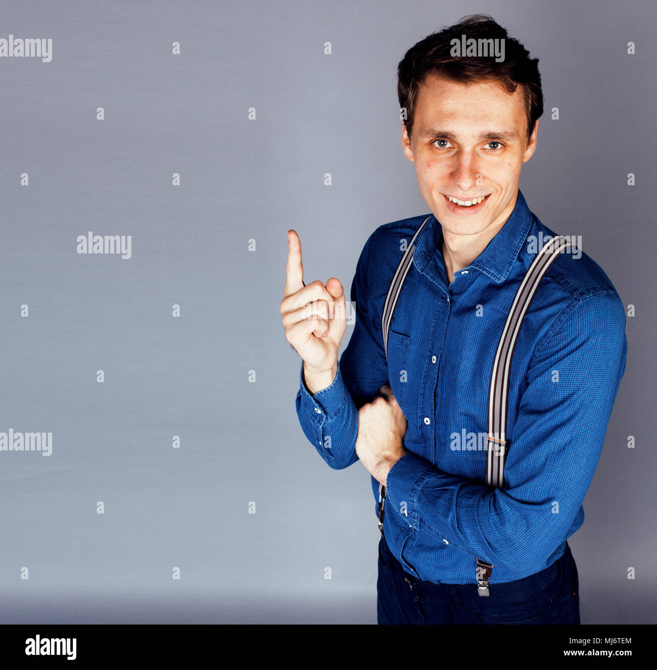 young goofy man with pimples pointing in studio, stupid bookwarm little ...