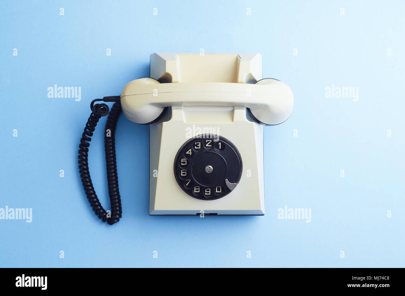 Retro rotary phone over blue background, above view Stock Photo - Alamy