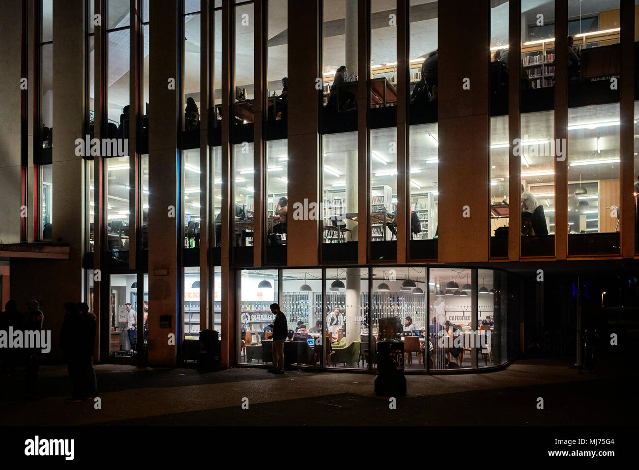 The students studying late at night in the library building at ...