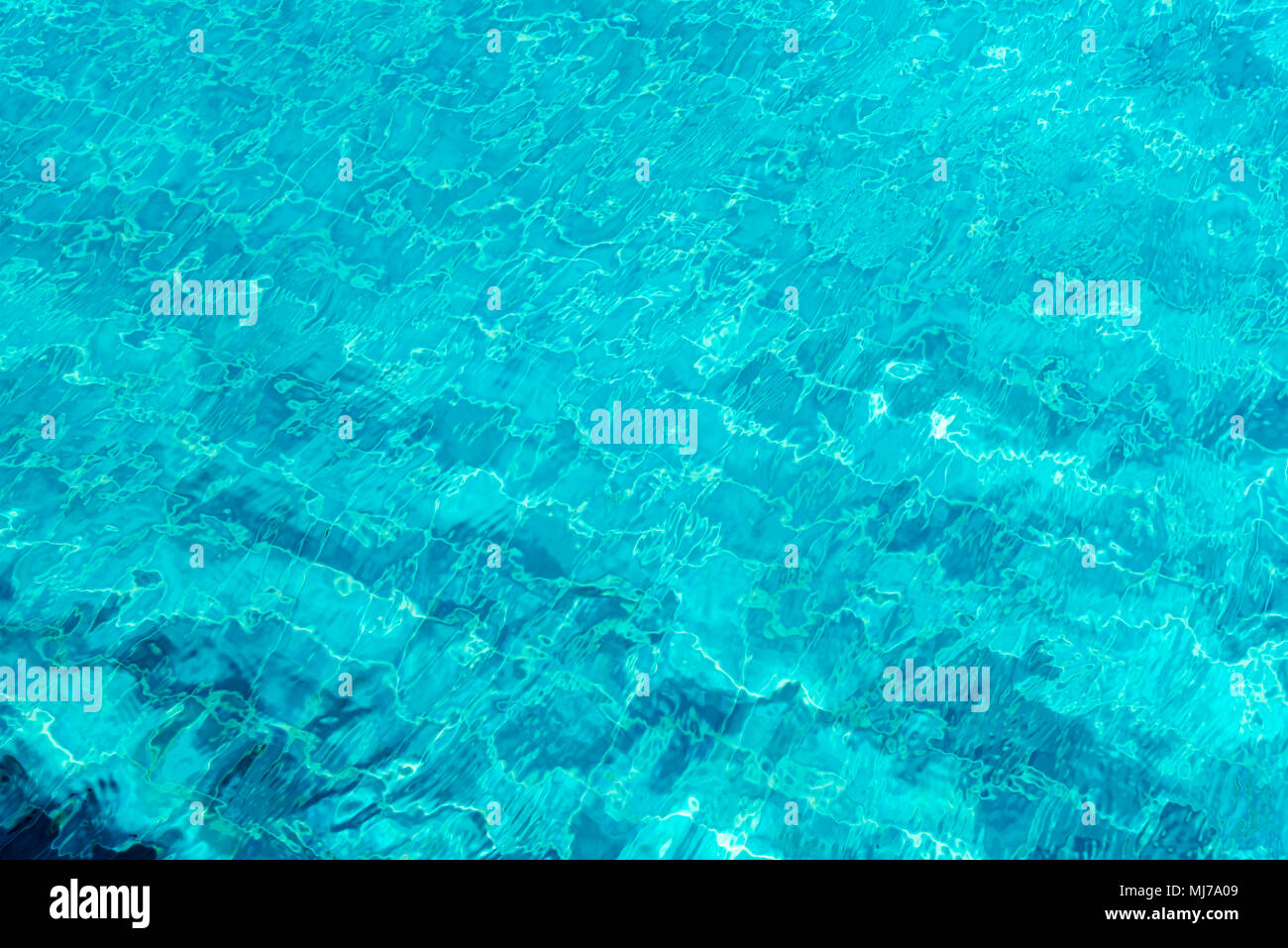A close up shot of water in swimming pool as the sunlight reflection ...