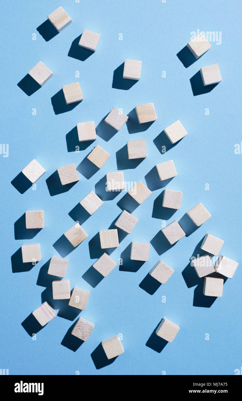 Wooden cubes spread over blue background, top view Stock Photo - Alamy