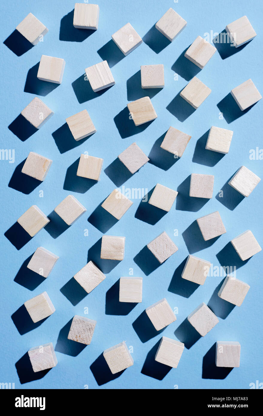 Wooden cubes spread over blue background, top view Stock Photo - Alamy