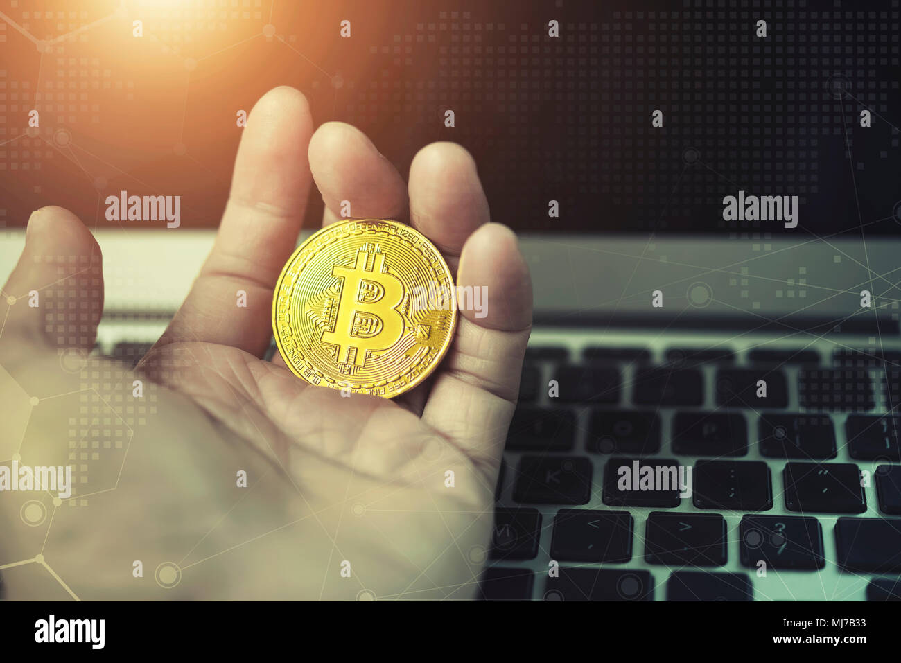 Bitcoin concept. Golden bitcoin on hand agent laptop computer with line ...