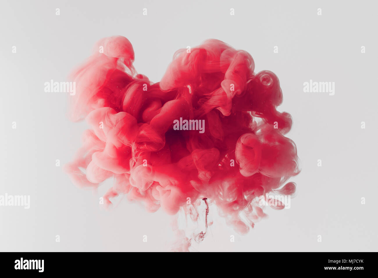 close up shot of bright red paint splash in water isolated on gray ...