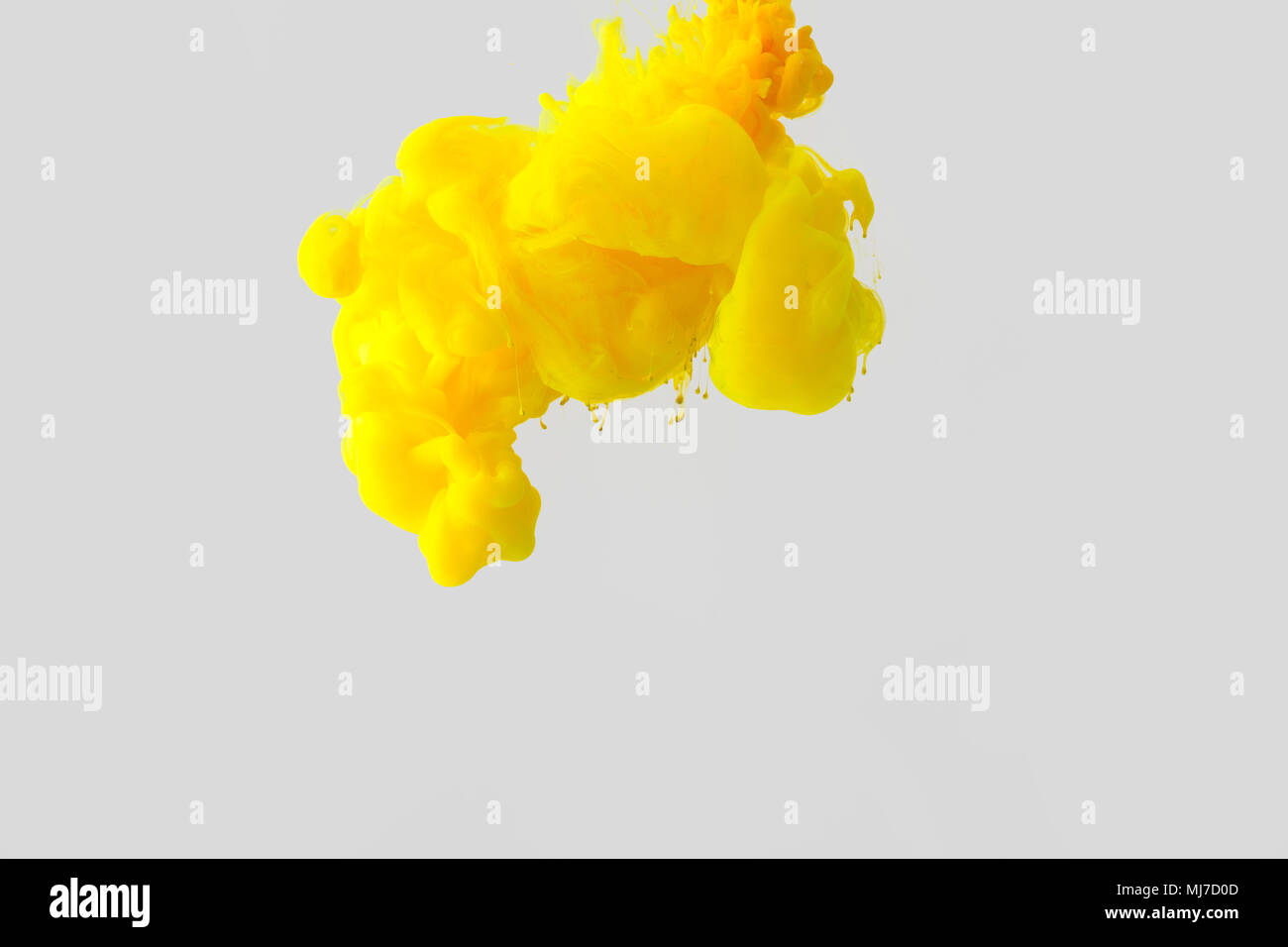 close up view of bright yellow paint splash in water isolated on gray ...