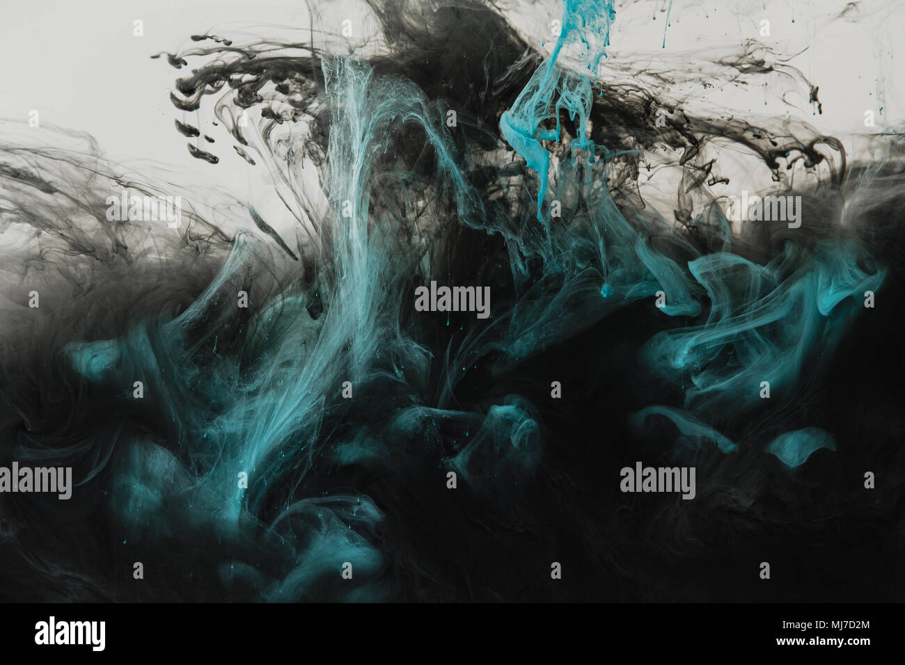 close up view of mixing of light gray, turquoise and black paints ...