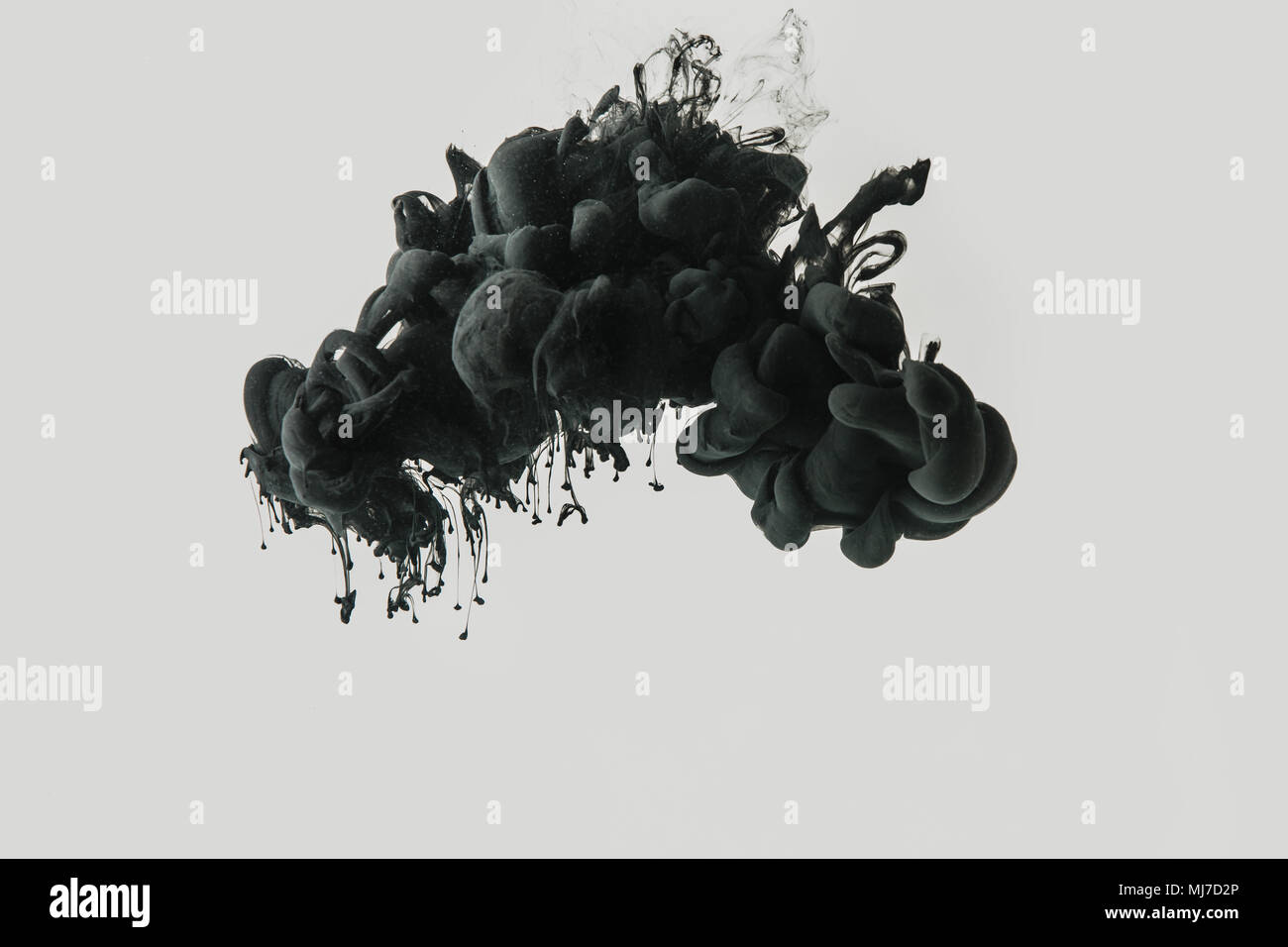 close up view of black paint splash in water isolated on gray Stock ...