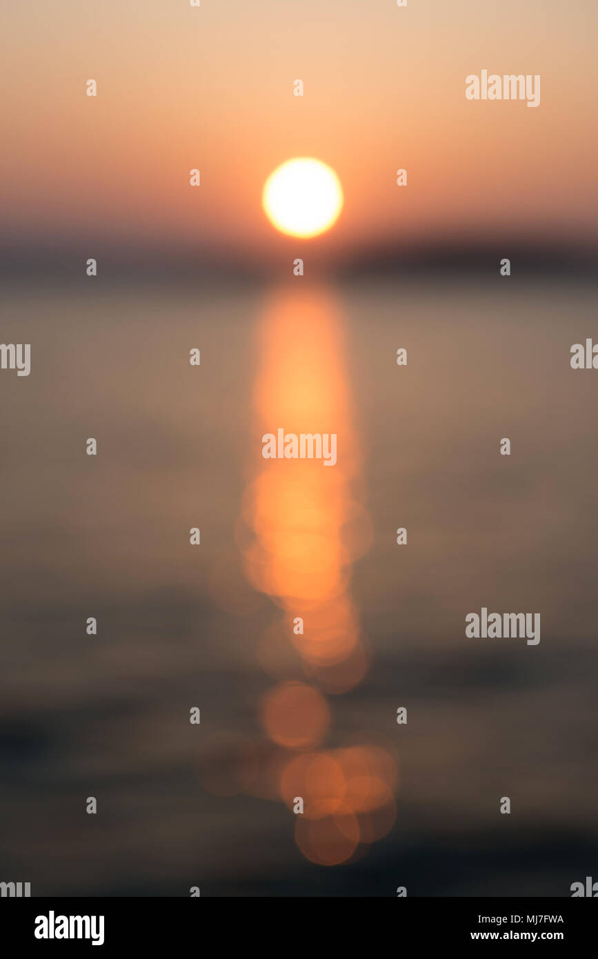 Defocused sun and the sea water in the evening. Sunset, background ...