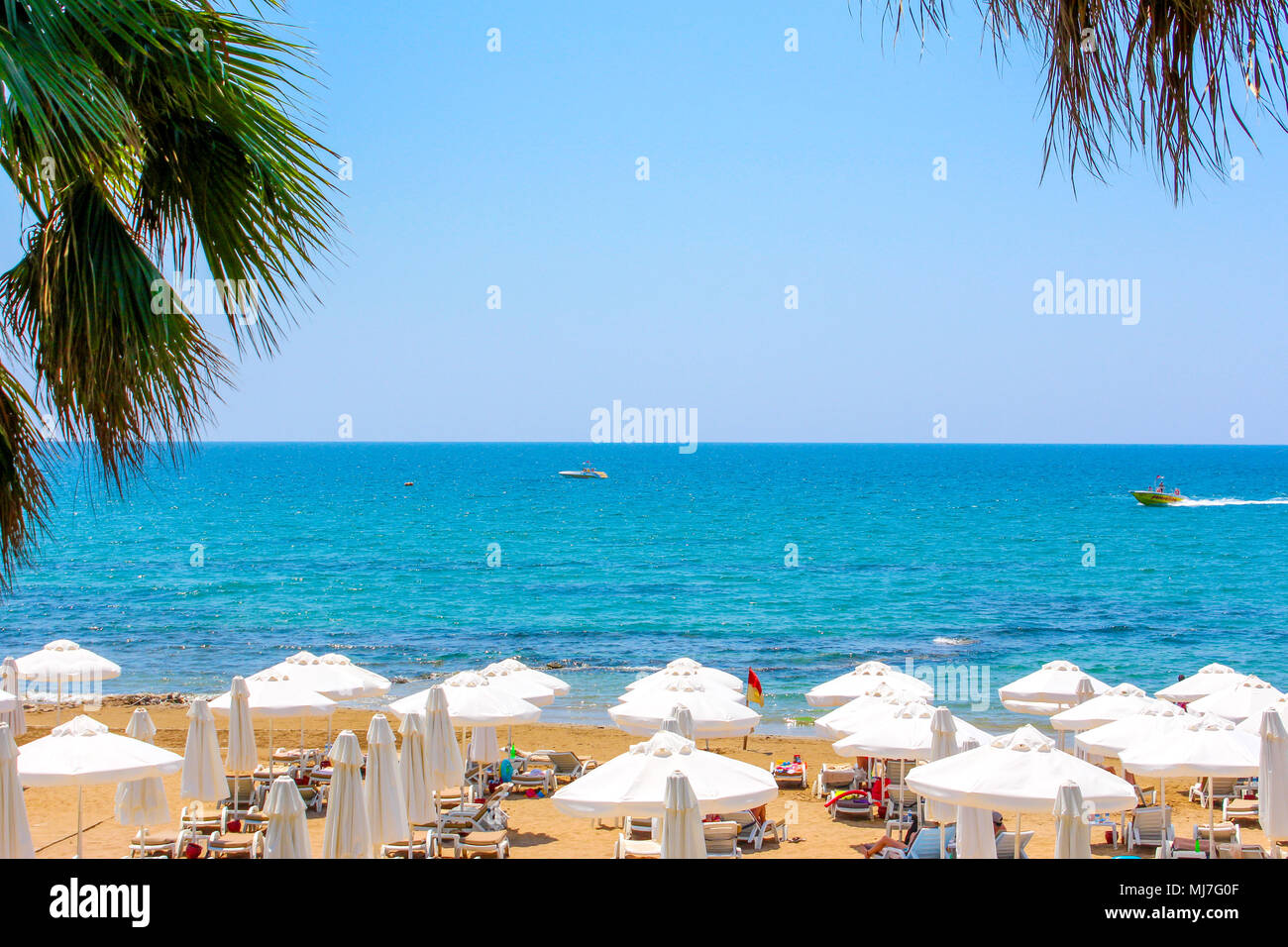 Beach view, beautiful turquoise ocean, beach with sunbeds and sun ...