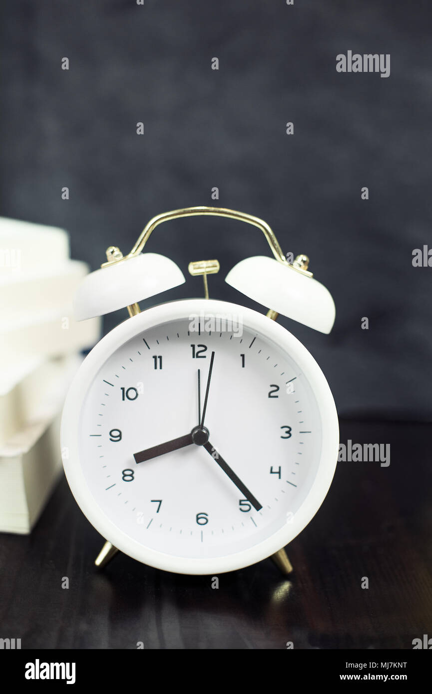 Close up white vintage clock on blur background Stock Photo - Alamy