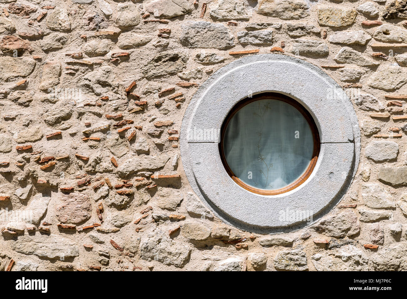 The circle window on stone wall, for background Stock Photo - Alamy