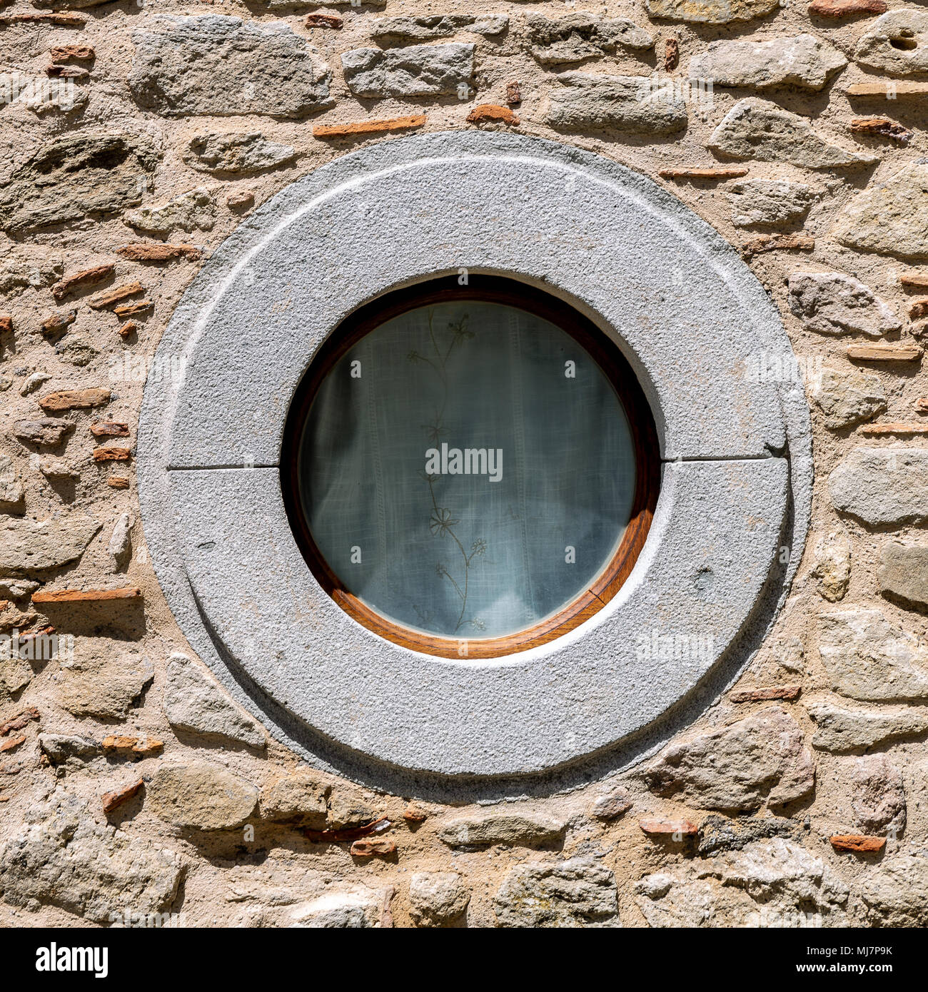The circle window on stone wall, for background Stock Photo - Alamy