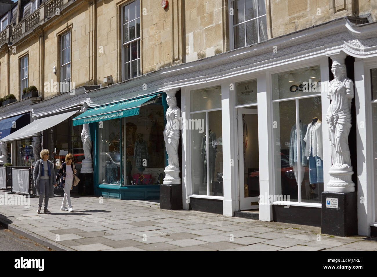 Two women walk past street hi-res stock photography and images - Alamy