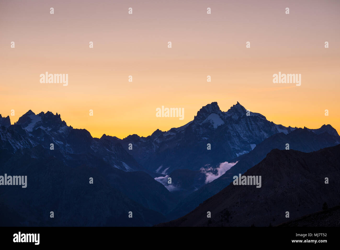 High altitude alpine landscape at dawn with first light glowing the ...