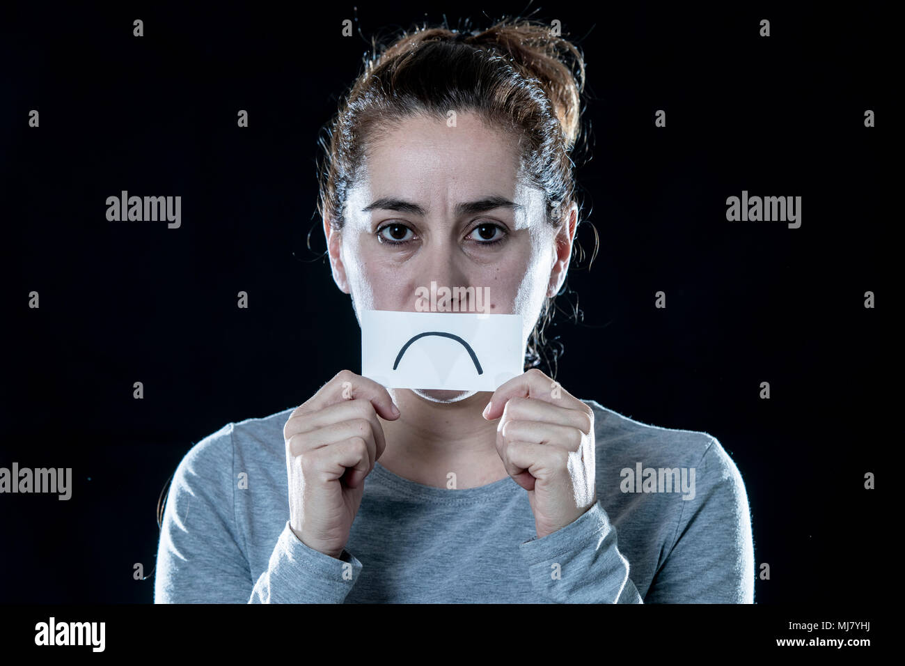 Young beautiful sad and depressed latin woman covering her sad face ...