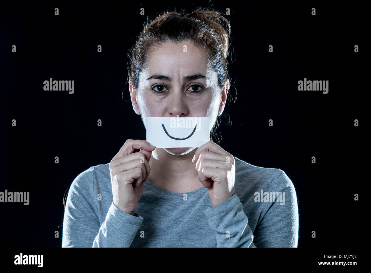 Young beautiful sad and depressed latin woman covering her sad face ...