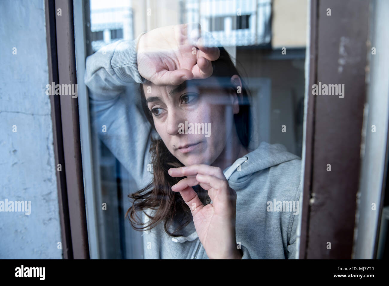 Sad women window hi-res stock photography and images - Alamy