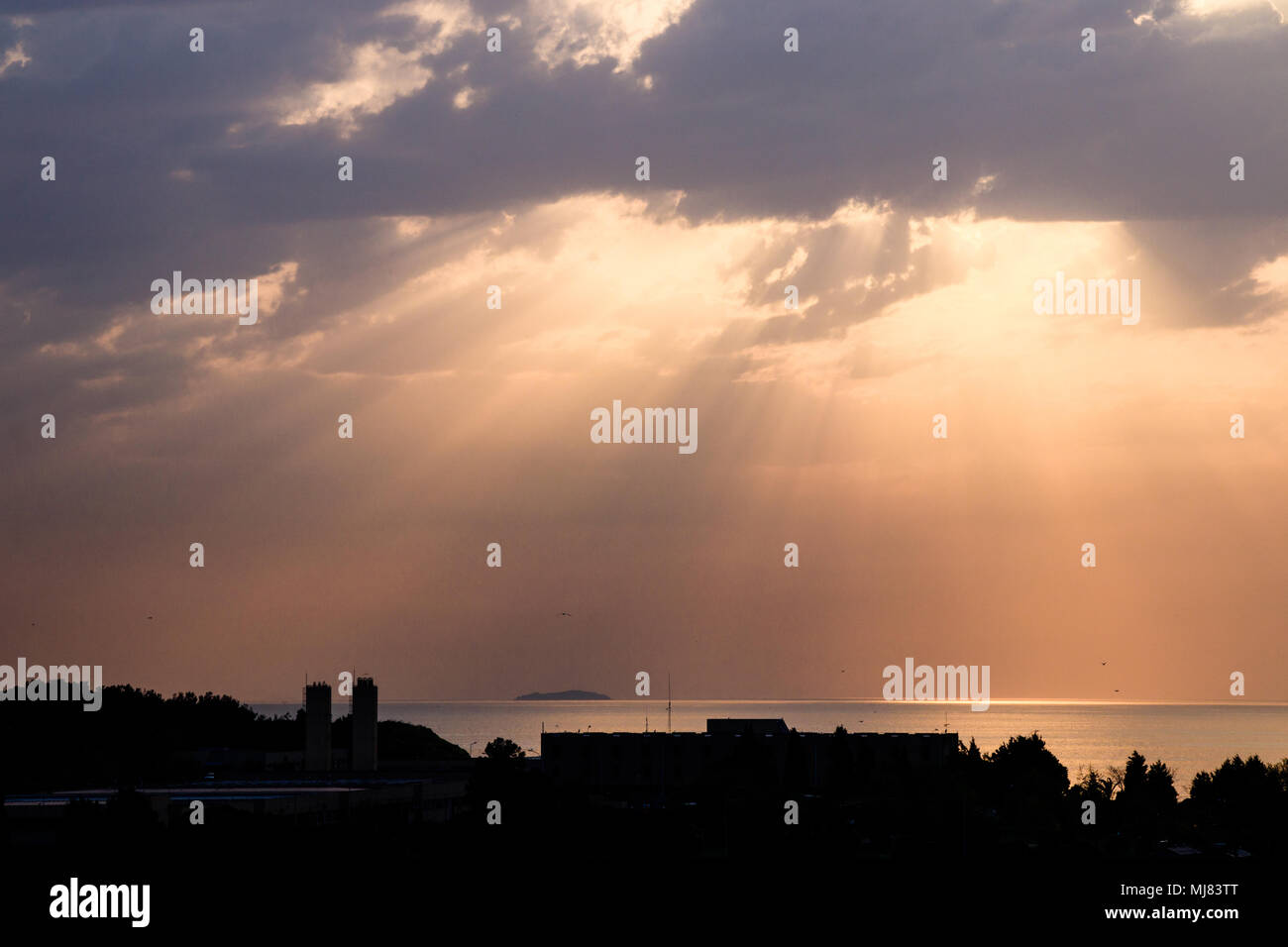 Cumulus sunset clouds with colorful sun setting downs Stock Photo - Alamy