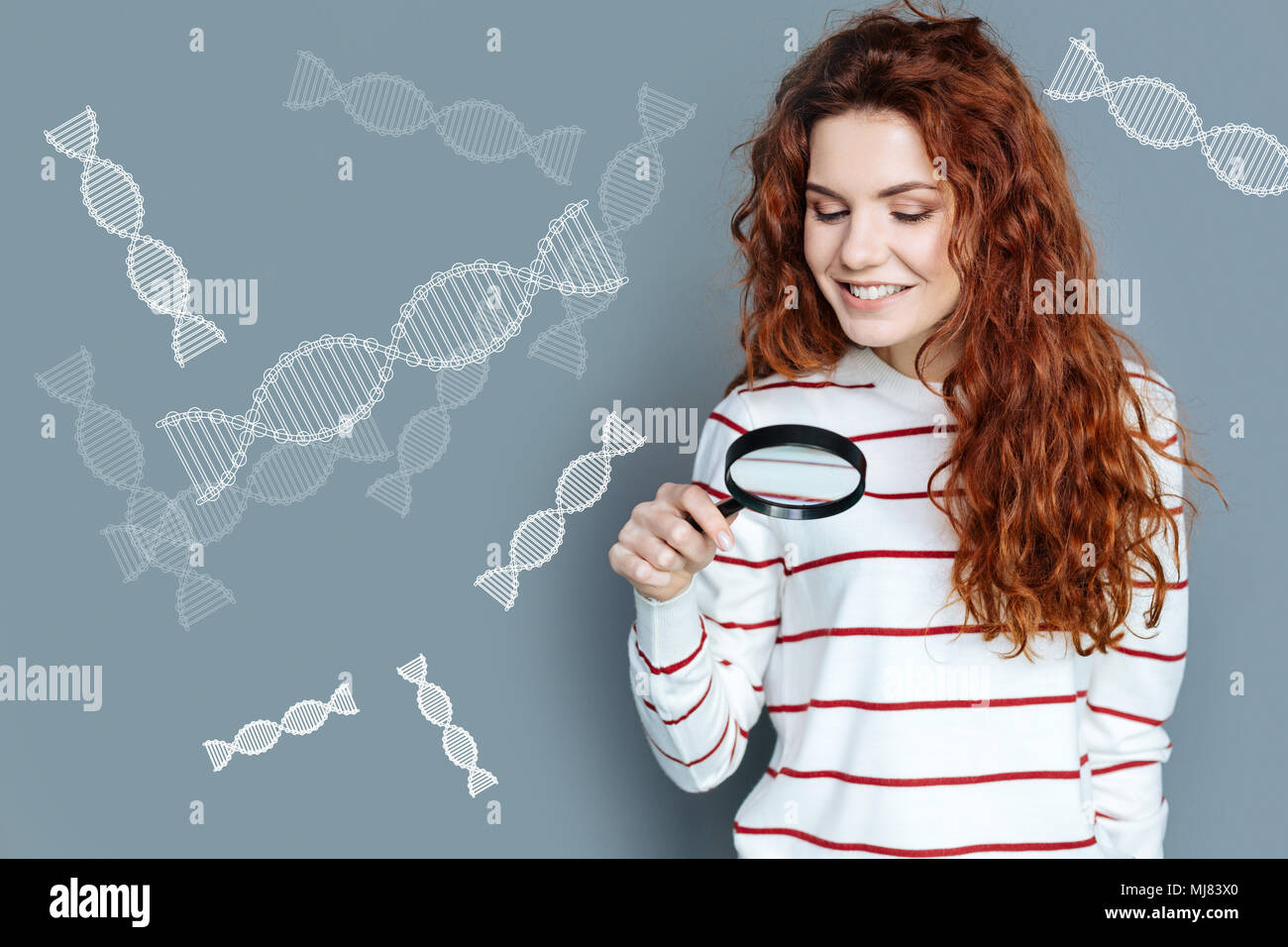 Young scientific worker smiling while making a DNA analysis Stock Photo ...