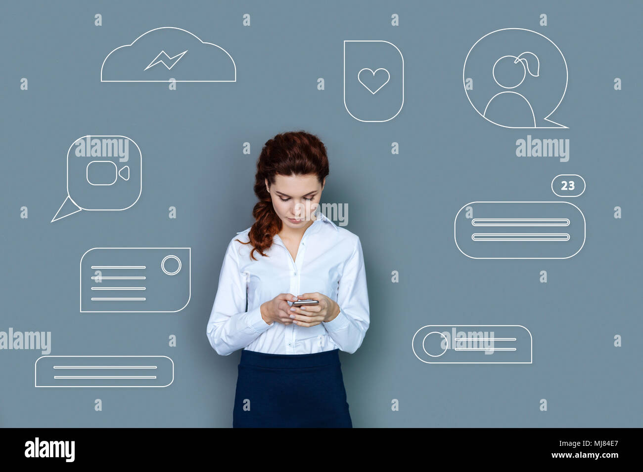 Calm HR manager looking at the screen while typing messages Stock Photo ...