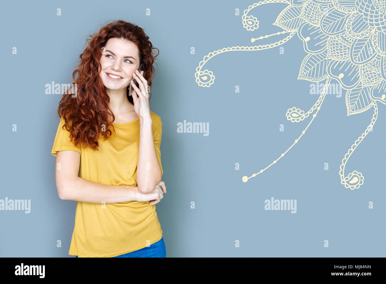 Emotional student smiling while having a friendly phone talk Stock ...