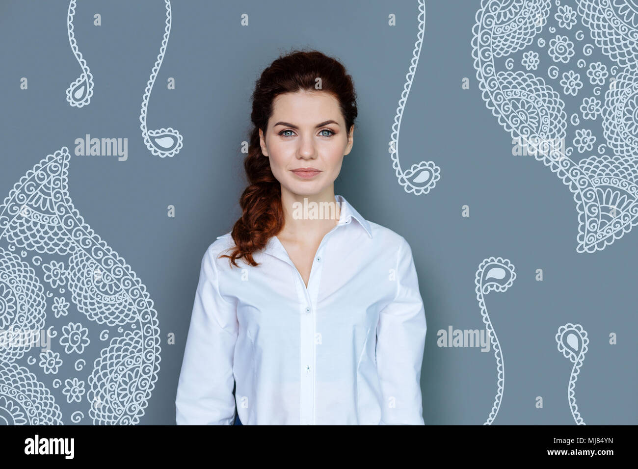 Calm teacher feeling good while waiting for her pupils Stock Photo - Alamy