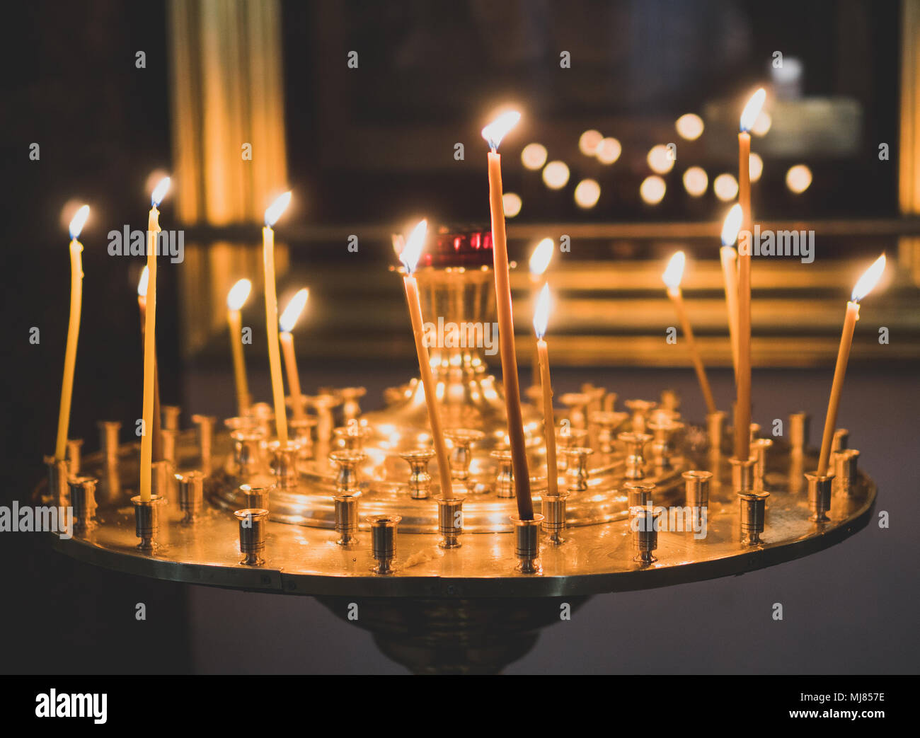 Metal candle light cresset in church Stock Photo - Alamy