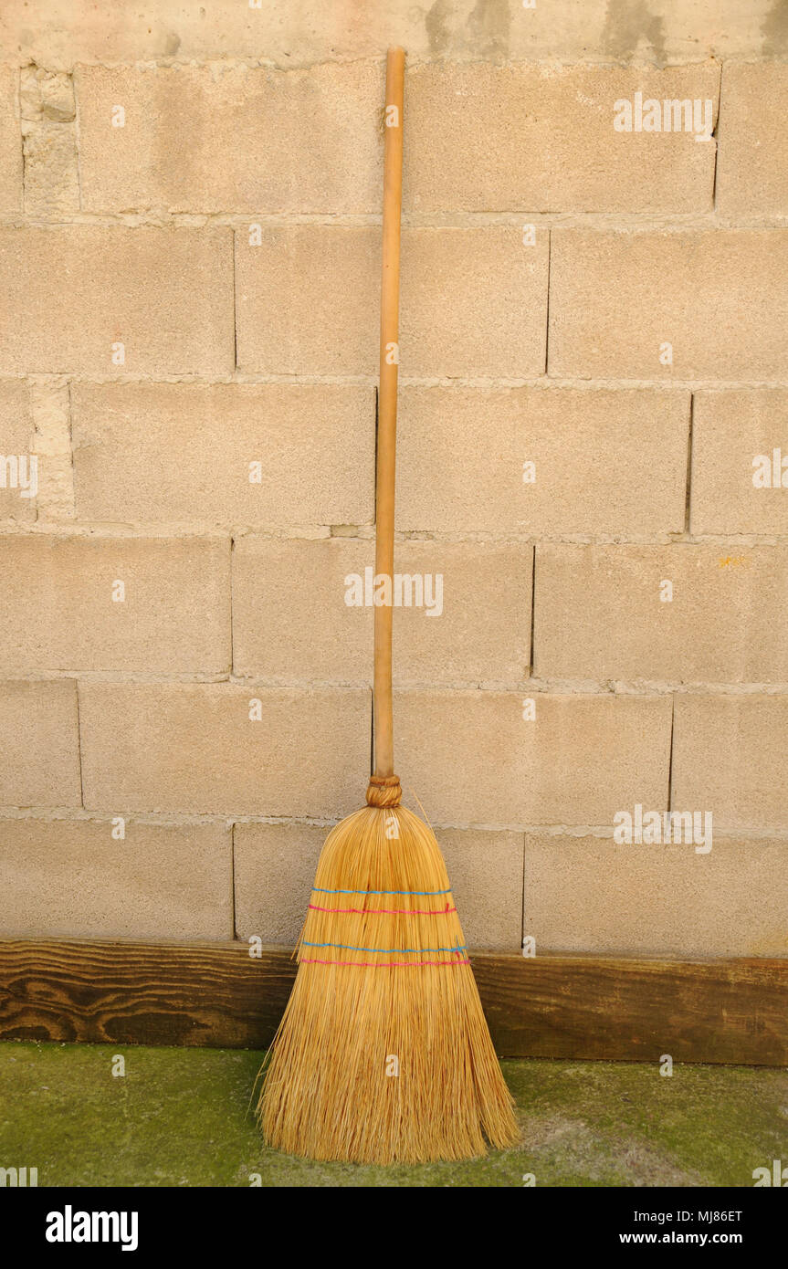 Broom by the wall vertical photo Stock Photo - Alamy