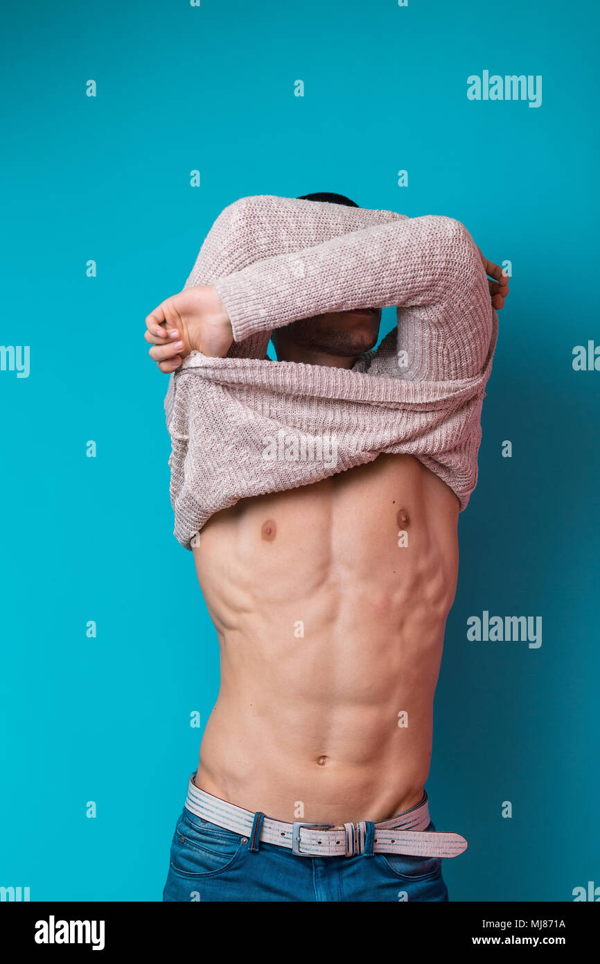 Man taking off his clothes Stock Photo - Alamy
