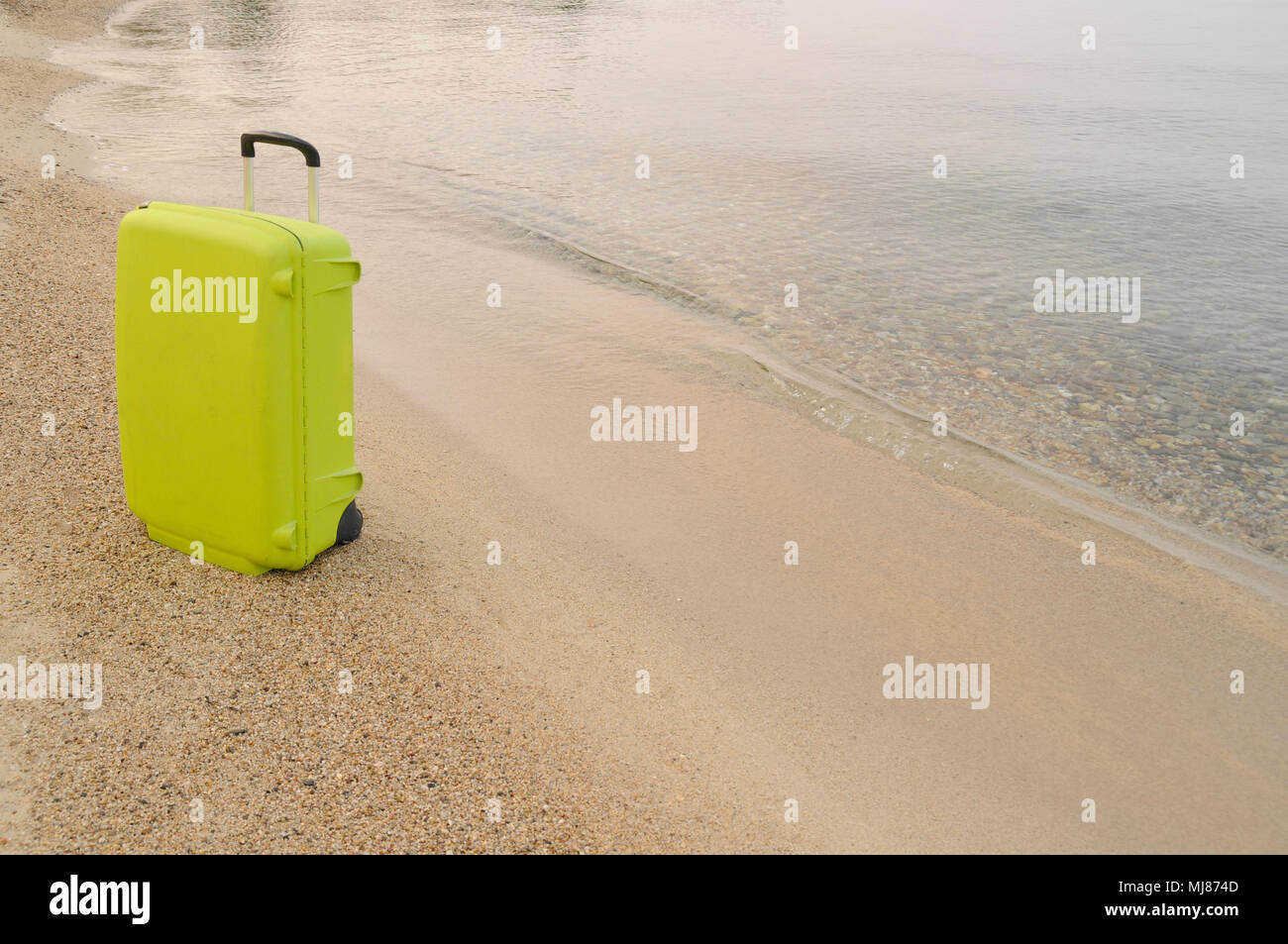 Lemon suitcase on the beach Stock Photo - Alamy