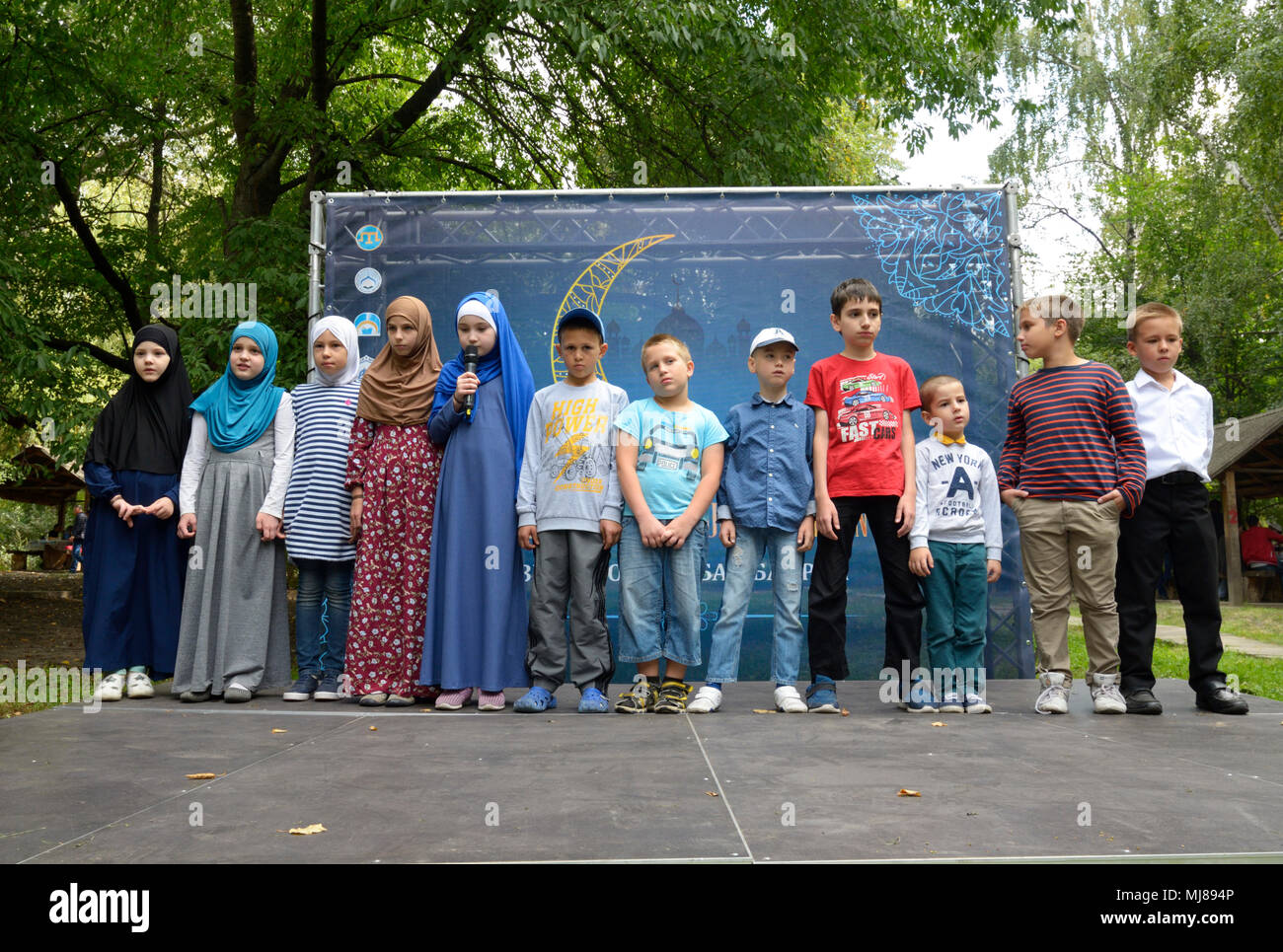 Muslim Crimean Tartar children standing on stage, one of them speaking ...