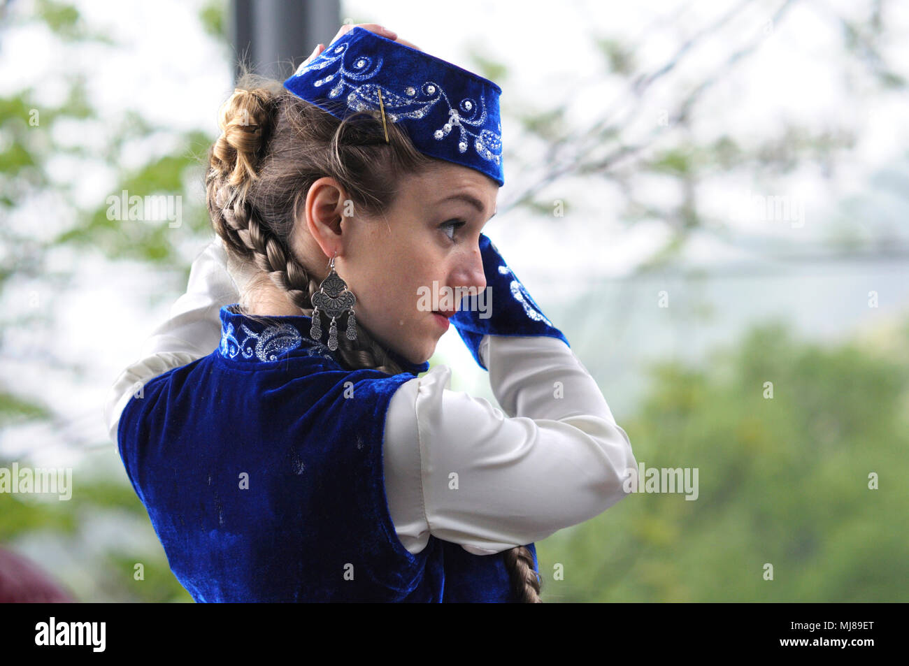 Crimean tatar dancer in native dress preparing for concert, dressing up ...