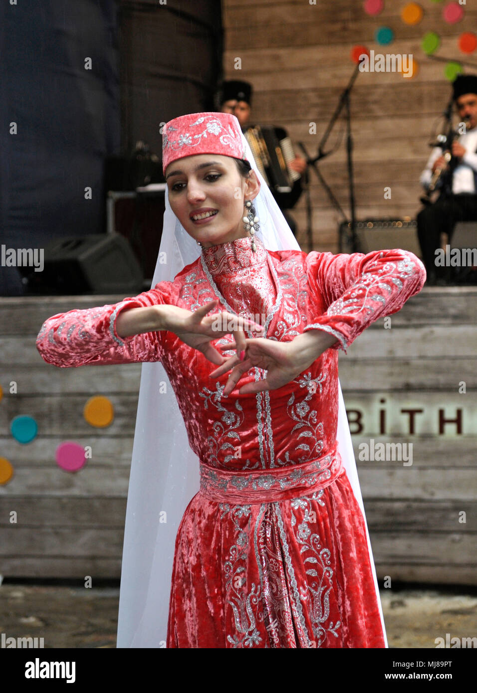 Crimean tatar dancer in a native dress performing native dance on stage ...