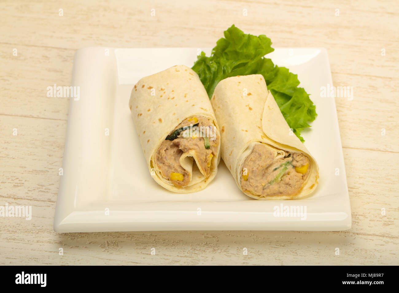 Tuna bread roll with salad leaves Stock Photo - Alamy